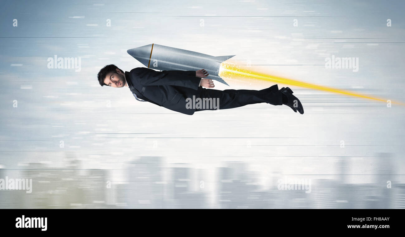 Superhero business man flying with jet pack rocket above the city Stock ...