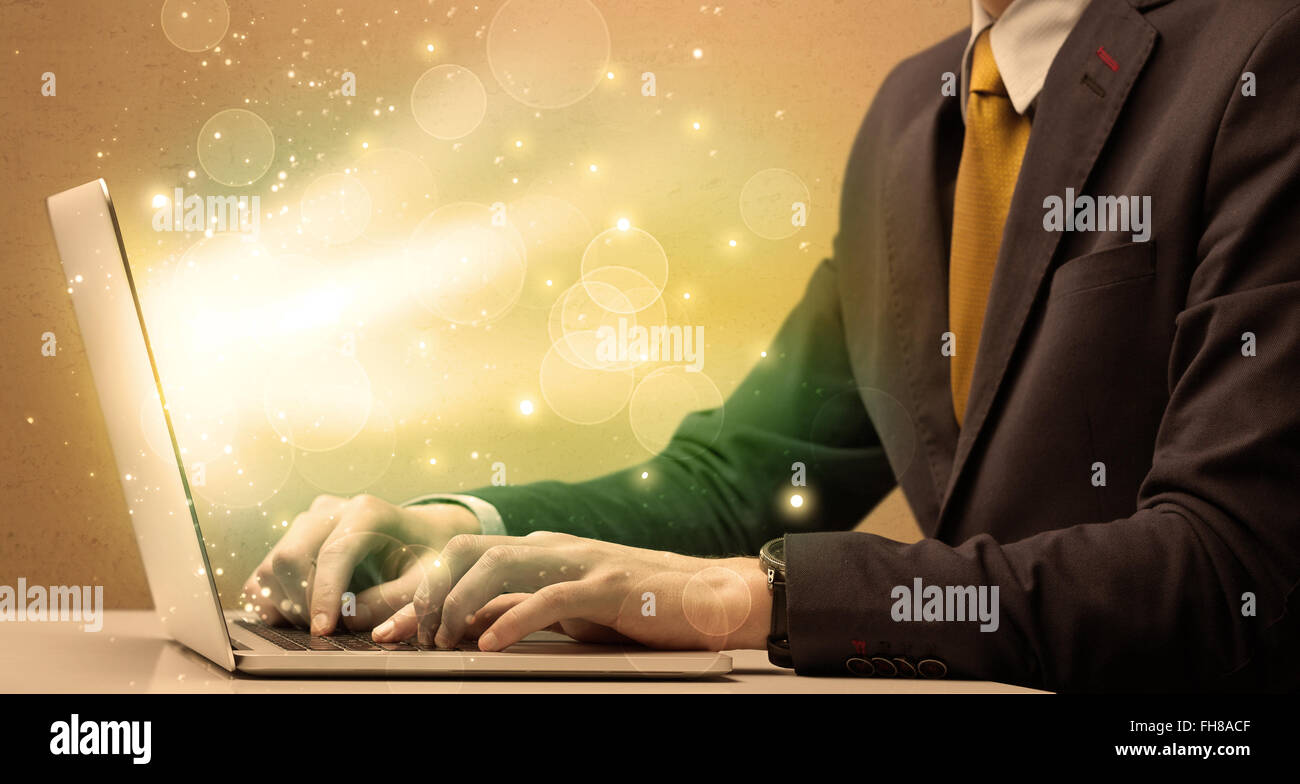 Businessman working fast on laptop Stock Photo - Alamy