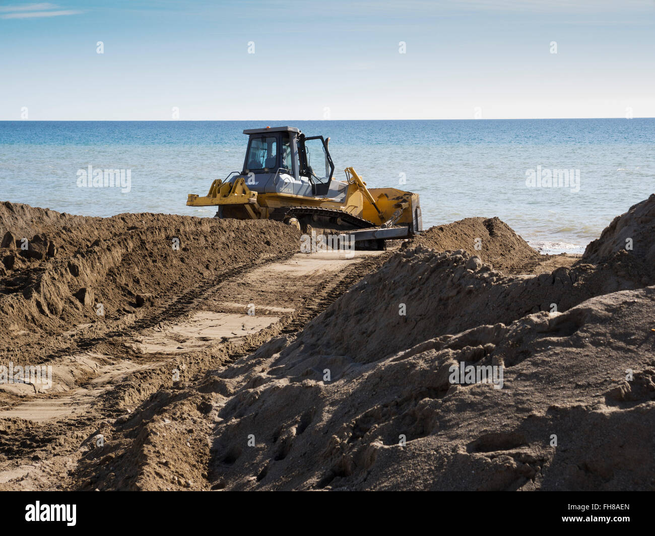 Bulldozer, Beach sand regeneration eroded by waves, Mijas Malaga ...