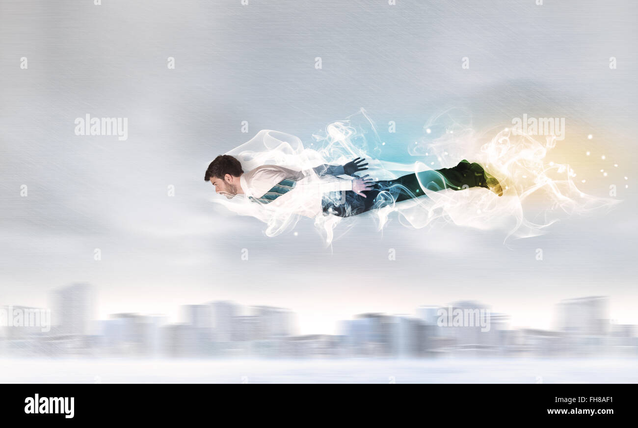 Hero superman flying above city with smoke left behind Stock Photo - Alamy