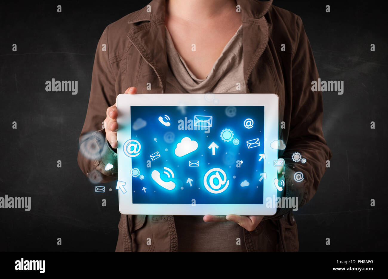 Person holding a tablet with blue technology icons and symbols Stock ...