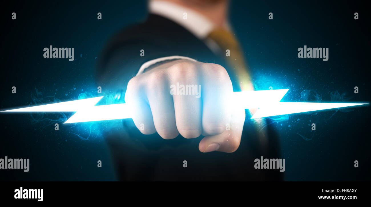 Business man holding glowing lightning bolt in his hands Stock Photo ...