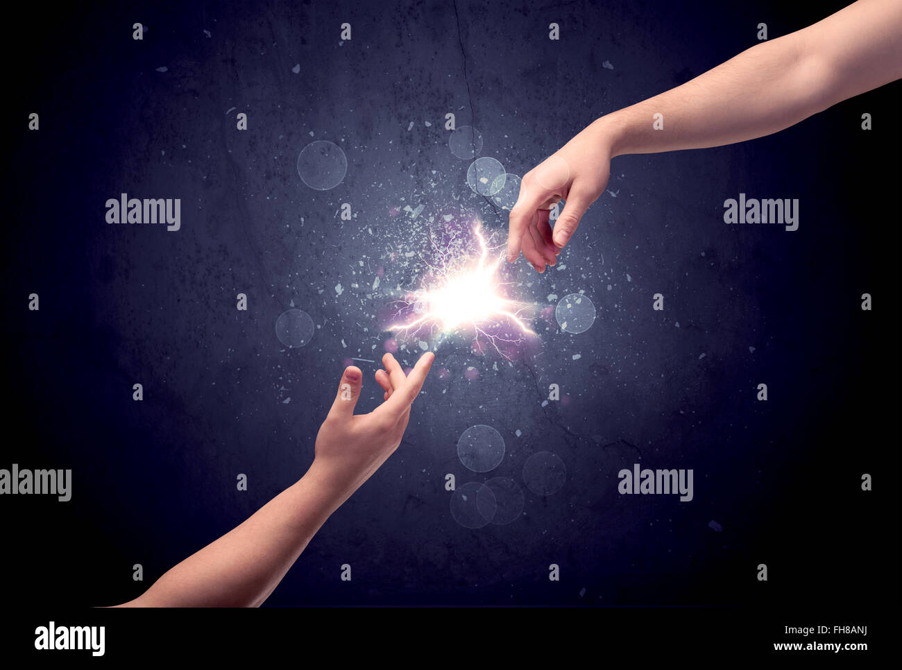 Hands reaching to light a spark Stock Photo - Alamy