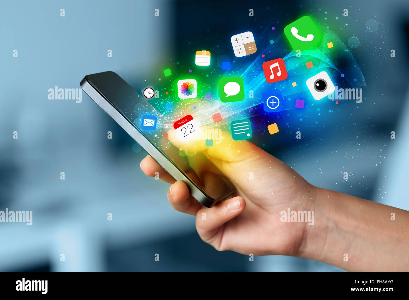 Hand holding smartphone with colorful app icons Stock Photo - Alamy