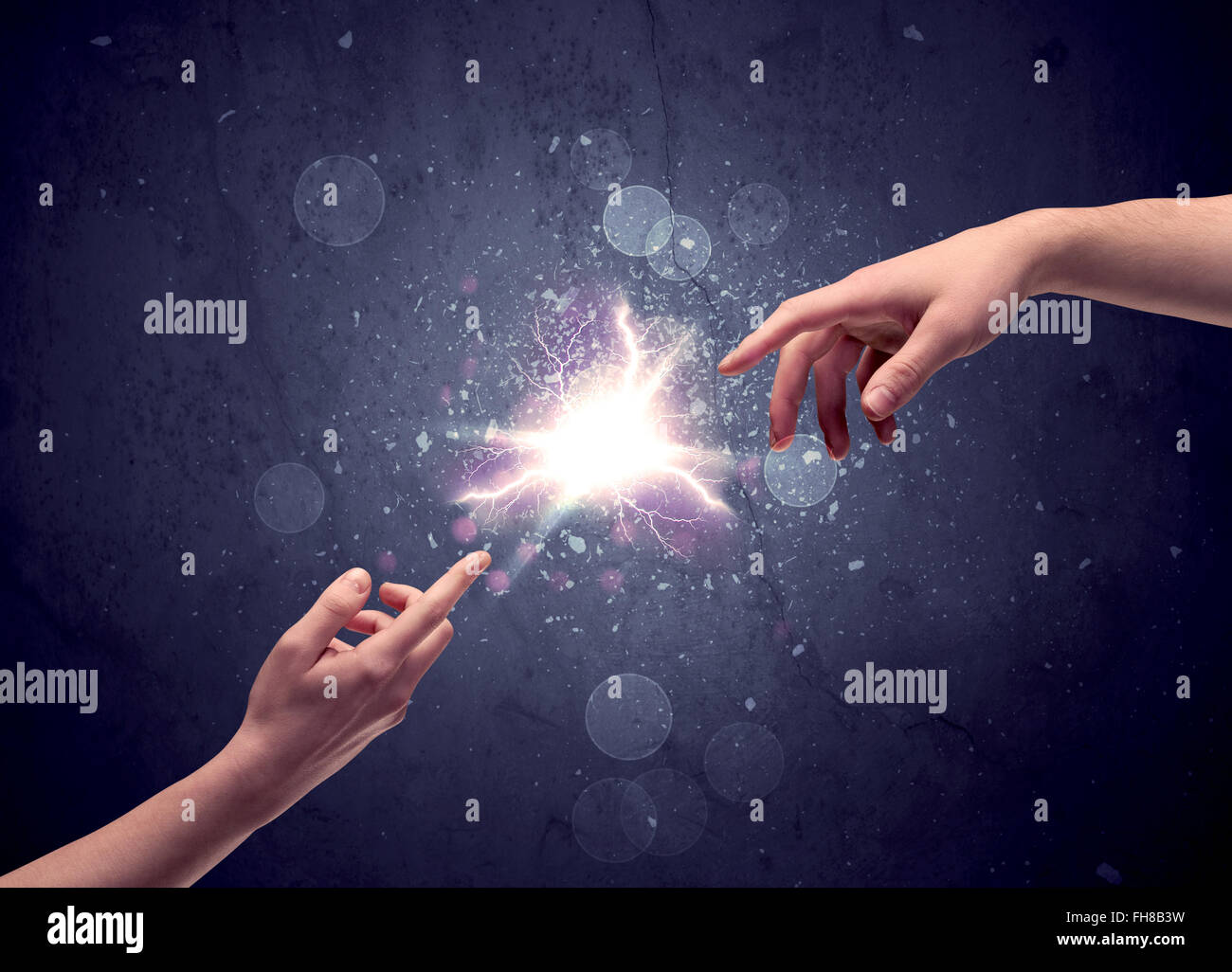 Hands reaching to light a spark Stock Photo - Alamy