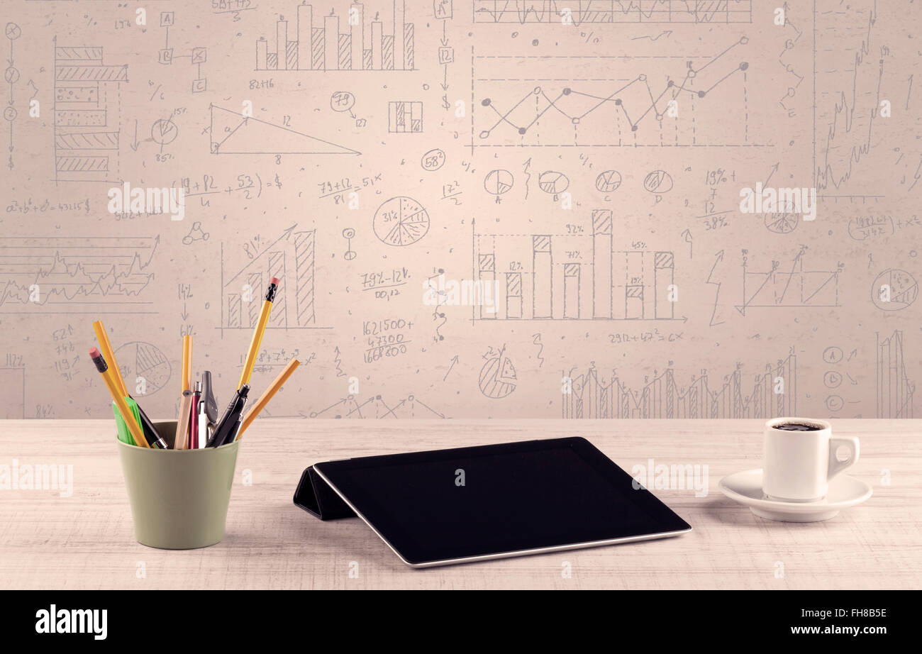Graph charts and designer office desk Stock Photo - Alamy