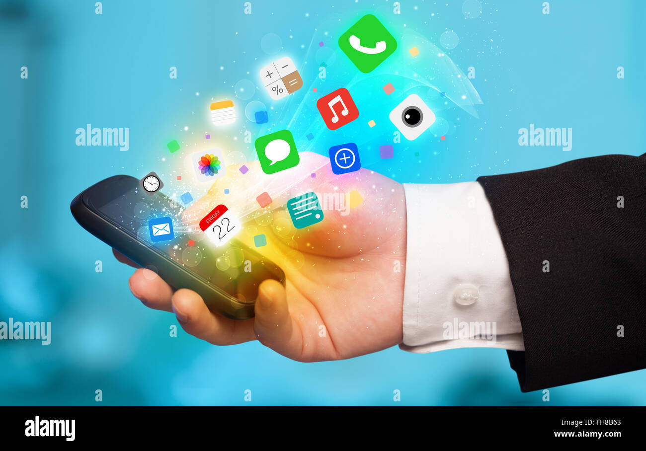 Hand holding smartphone with colorful app icons Stock Photo - Alamy