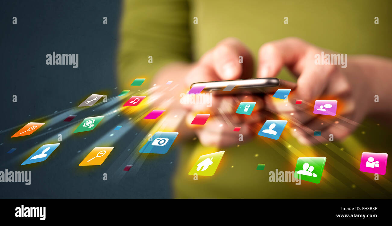Man holding smartphone with technology application icons Stock Photo ...