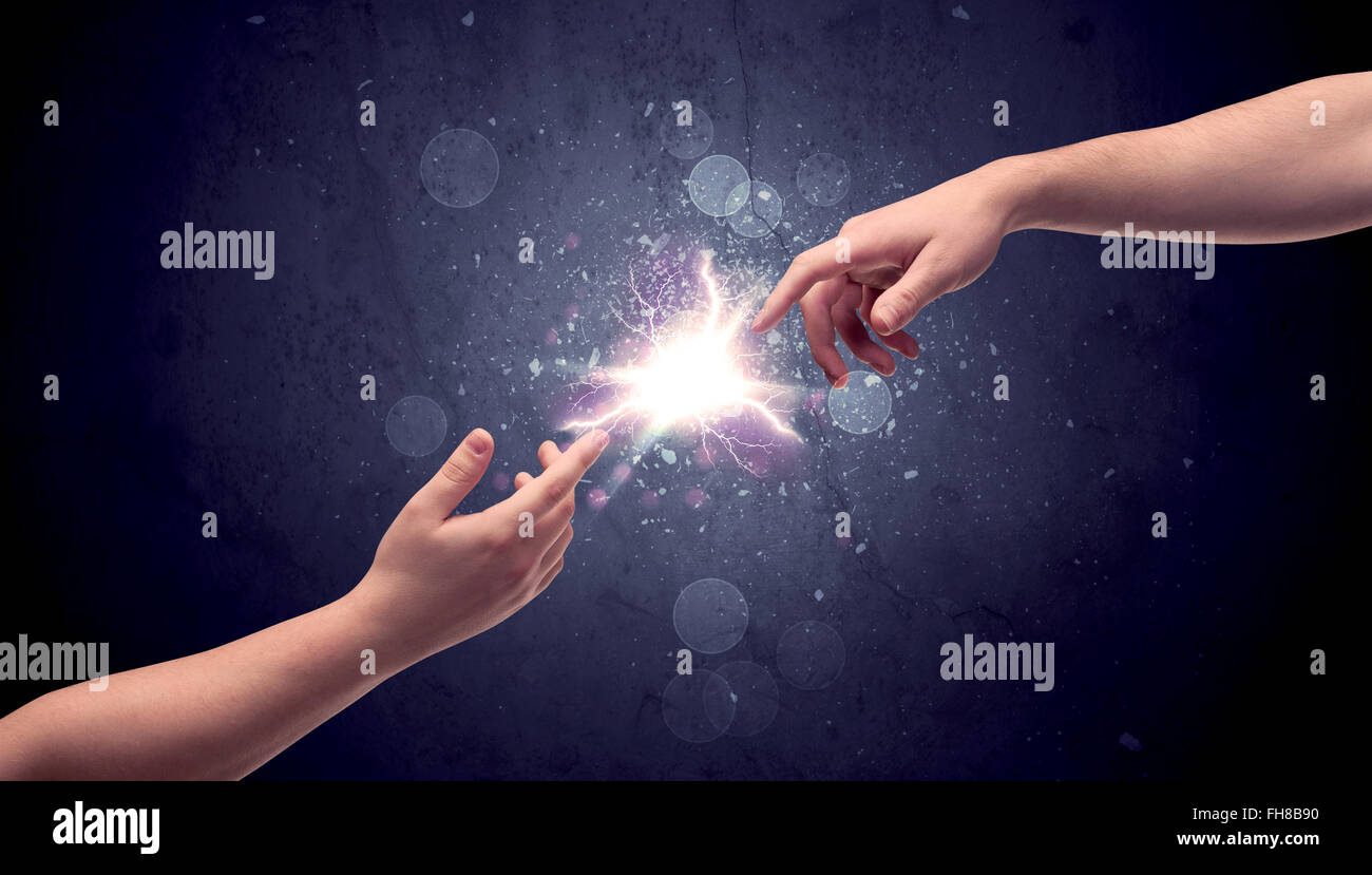 Hands reaching to light a spark Stock Photo - Alamy