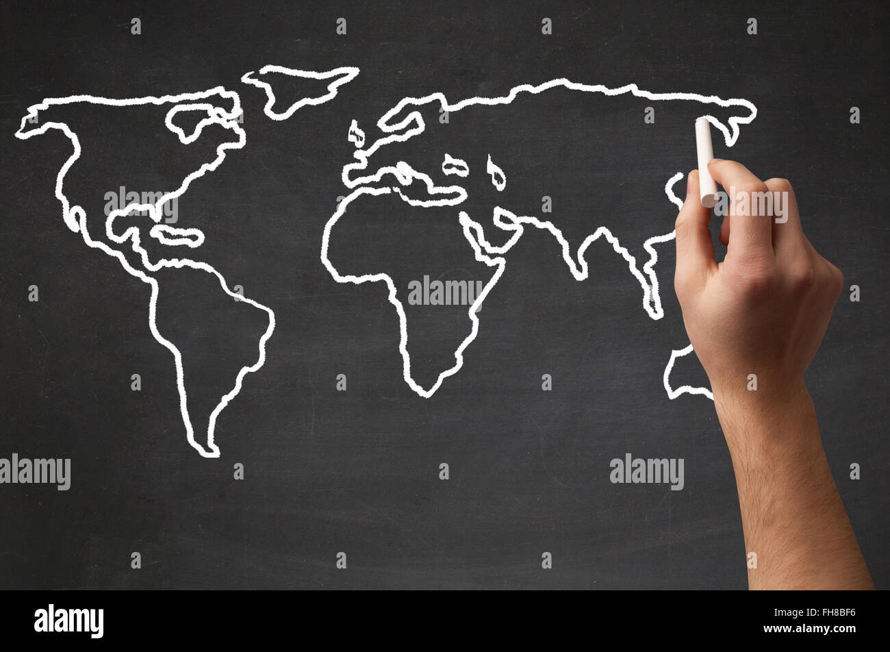 Adult drawing world map on chalkboard Stock Photo - Alamy