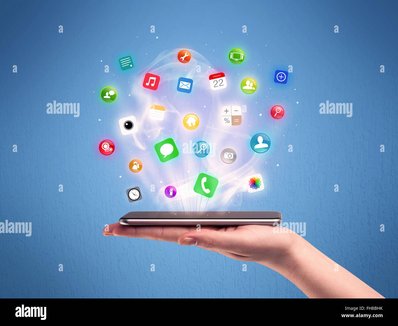 Hand holding tablet phone with app icons Stock Photo - Alamy