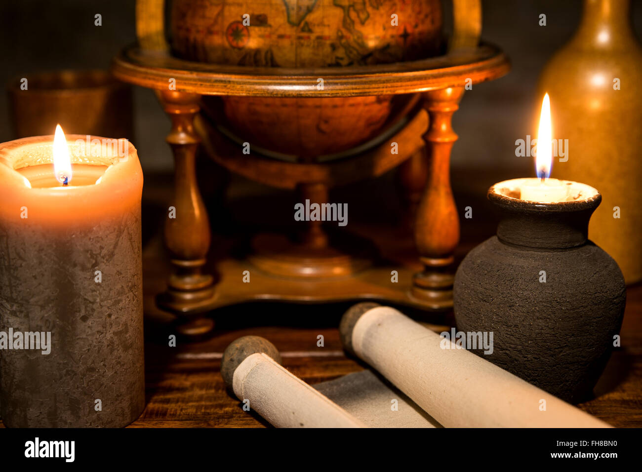 a old scroll with a globe and candles, concept adventure and traveling ...