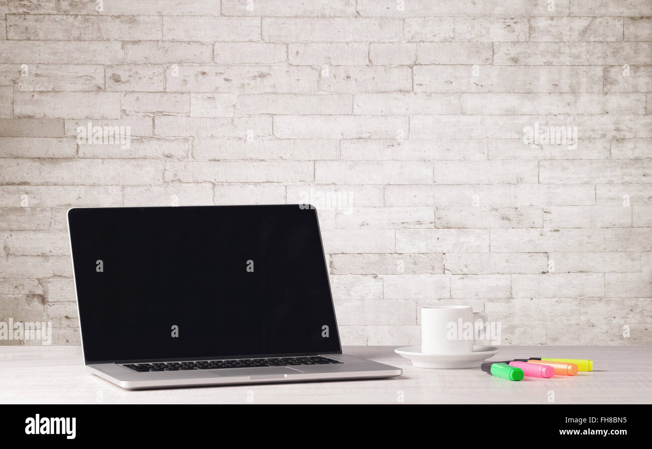 Business laptop with white brick wall Stock Photo - Alamy