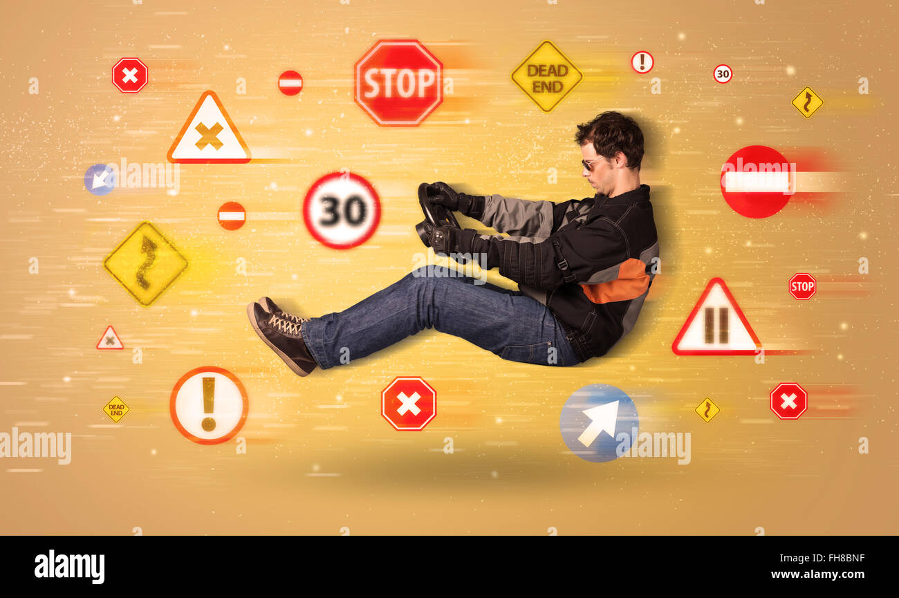 Young driver with road signs around him Stock Photo - Alamy