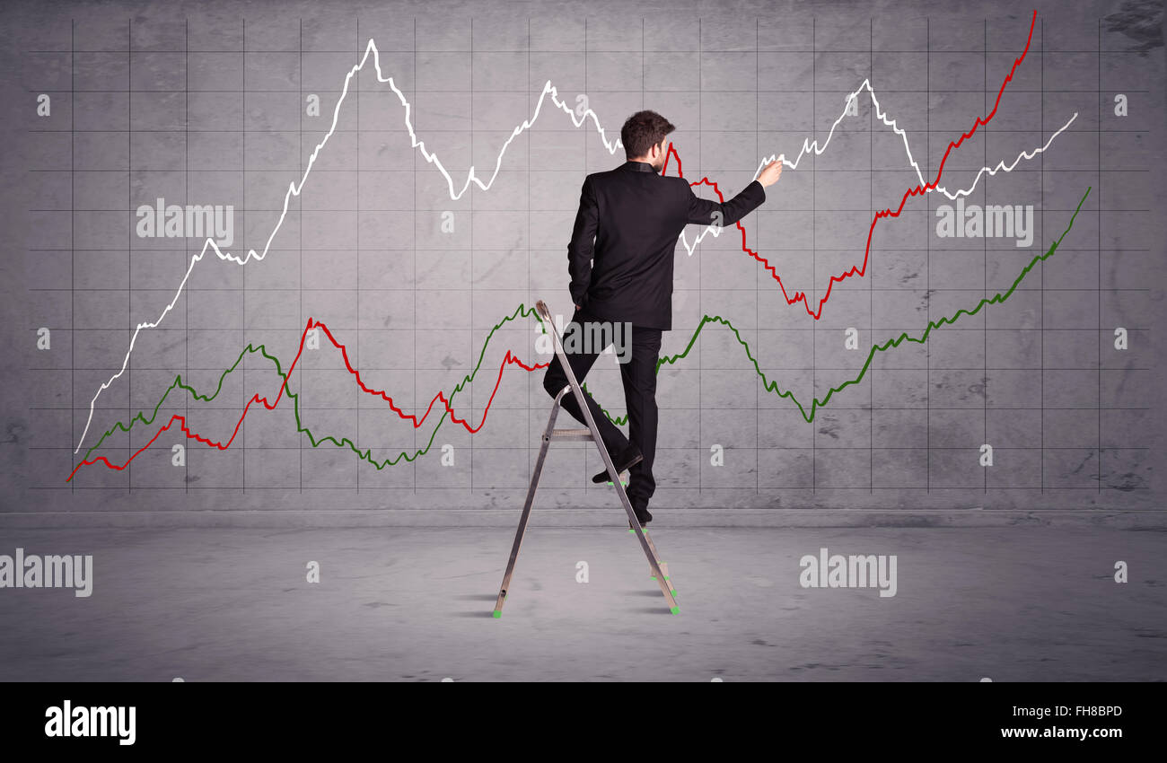 male on ladder drawing chart lines Stock Photo - Alamy