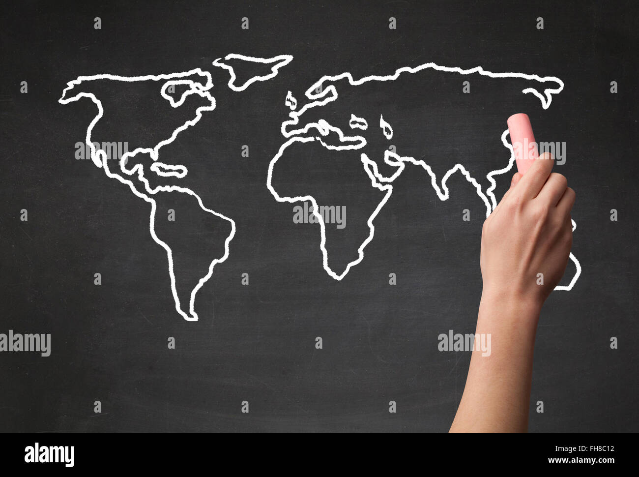 Adult drawing world map on chalkboard Stock Photo - Alamy