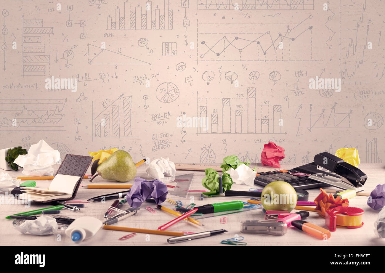 Graph charts and designer office desk Stock Photo - Alamy