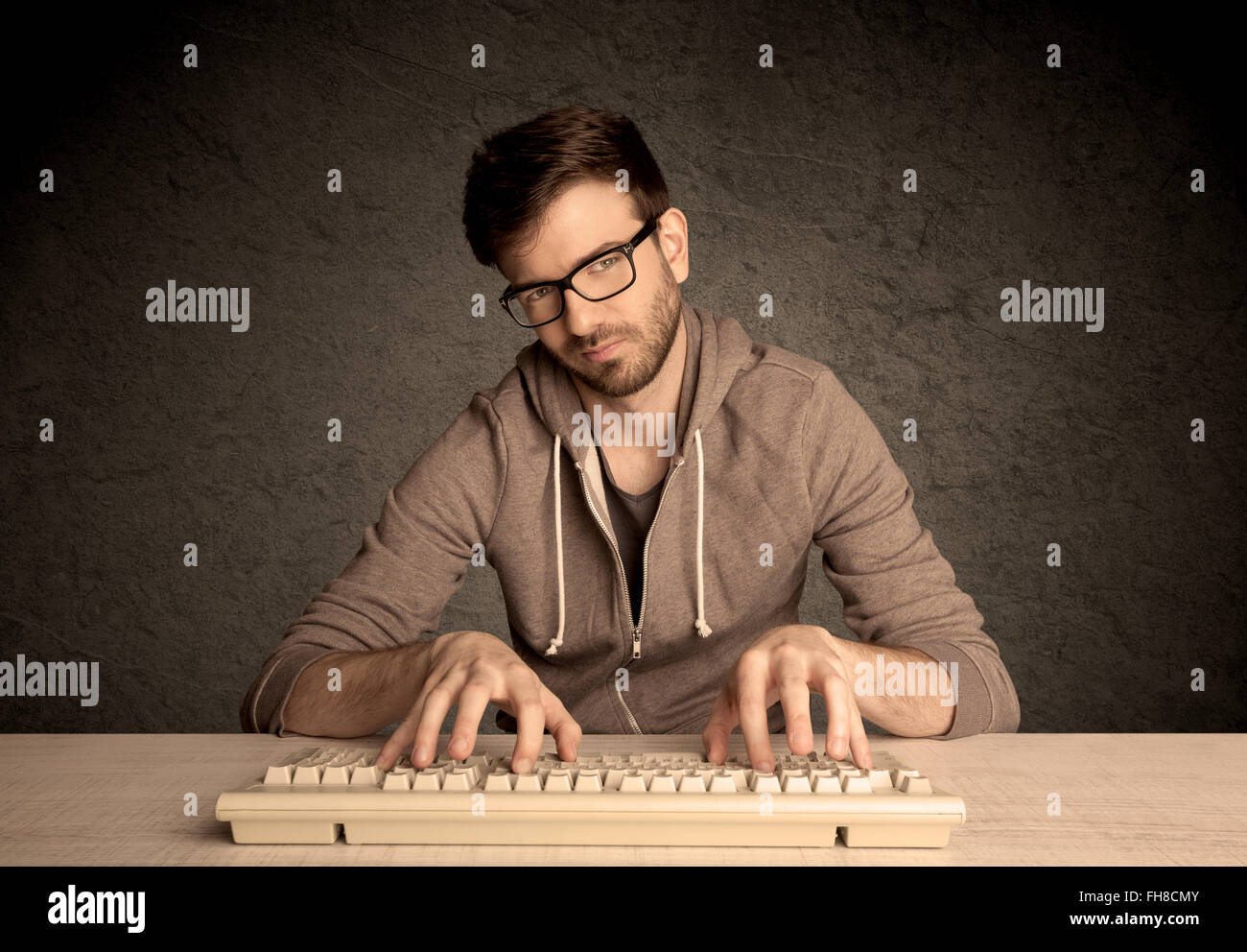 Computer geek typing on keyboard Stock Photo - Alamy