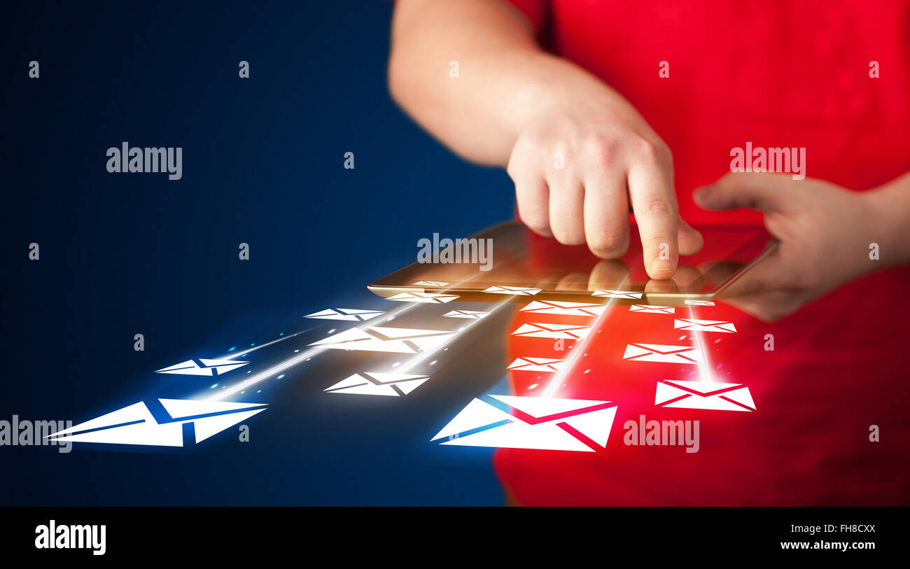 Hand holding tablet and sending email icons Stock Photo - Alamy