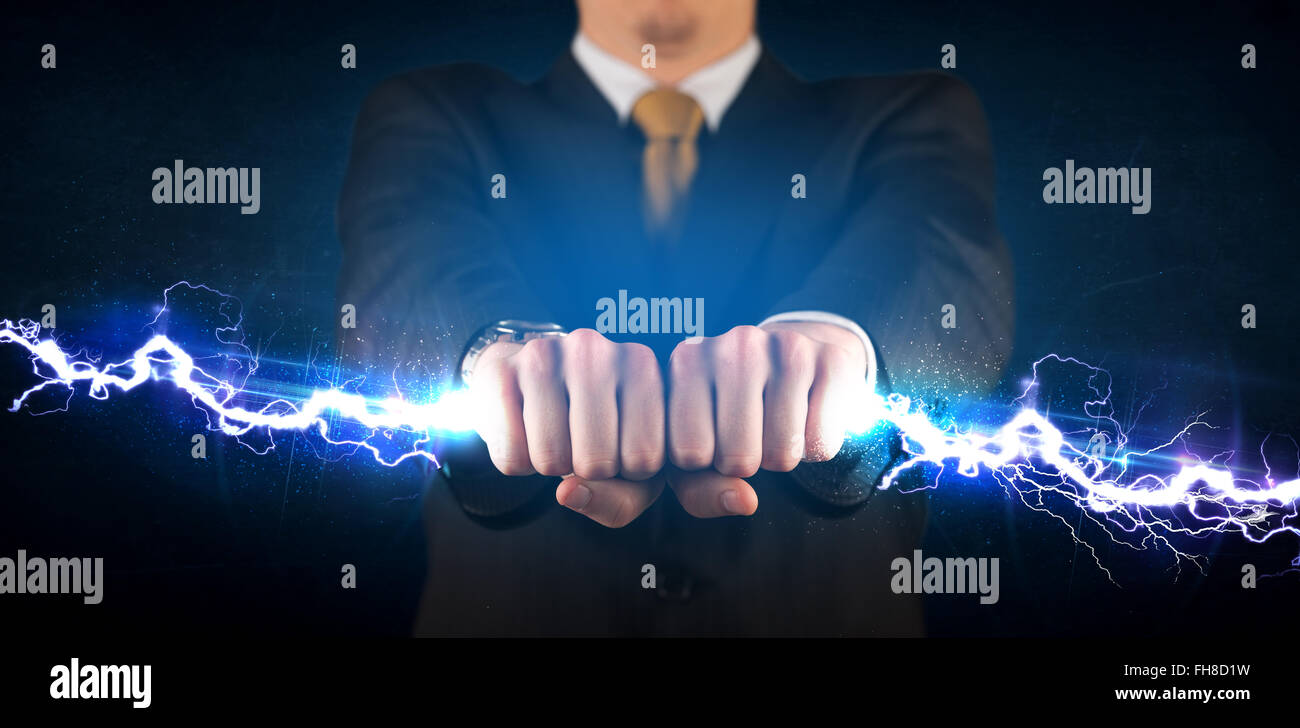 Business man holding electricity light bolt in his hands Stock Photo ...