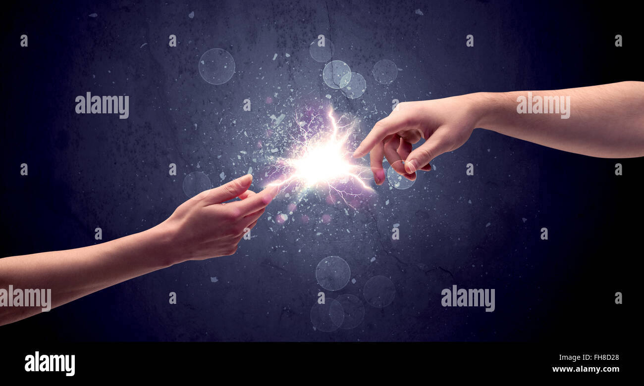 Hands reaching to light a spark Stock Photo - Alamy