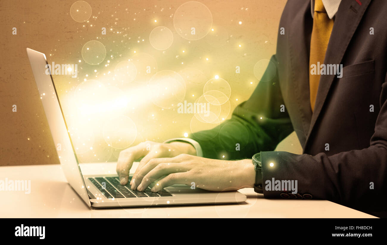 Businessman working fast on laptop Stock Photo - Alamy