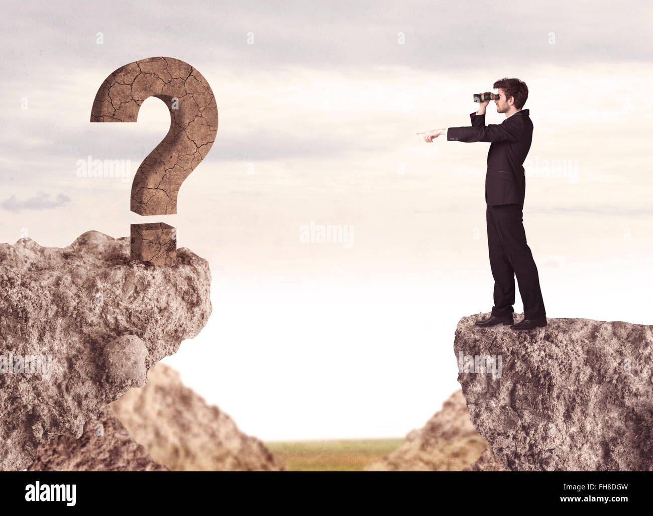 Businessman on rock mountain with a question mark Stock Photo - Alamy