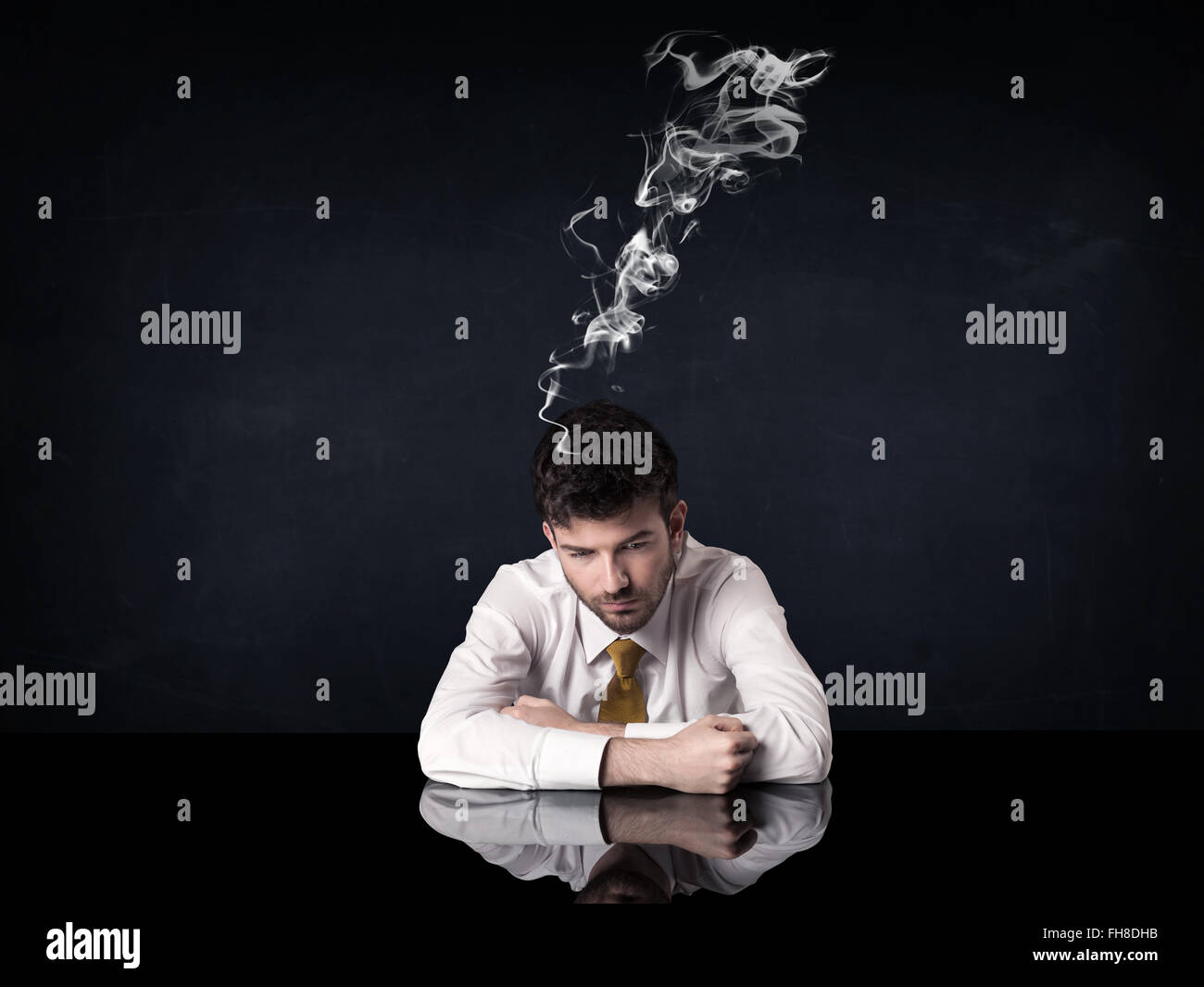Depressed businessman with smoking head Stock Photo - Alamy