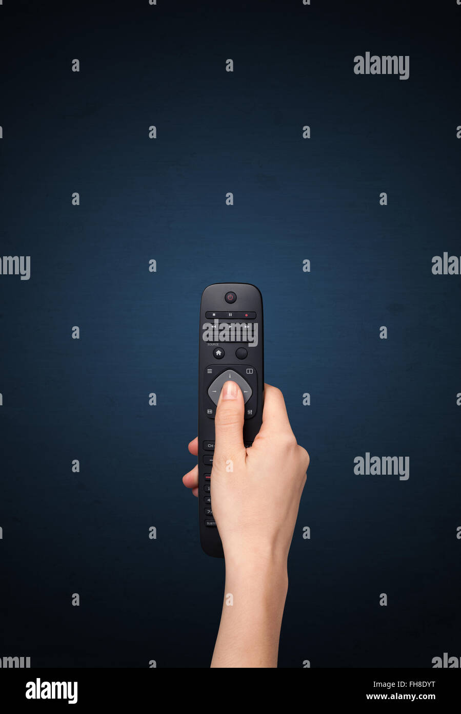Hand with remote control Stock Photo - Alamy