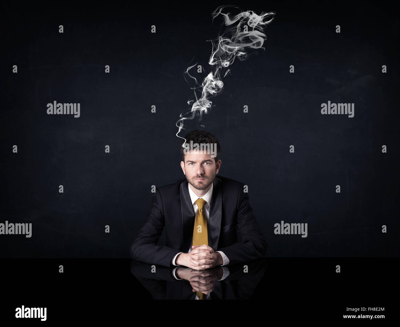 Depressed businessman with smoking head Stock Photo - Alamy