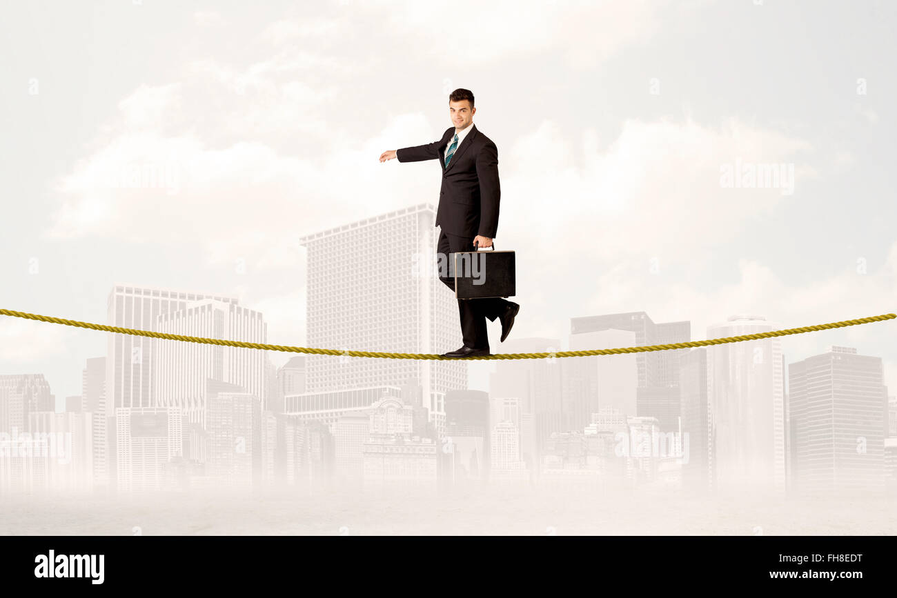 Business person balancing on golden rope Stock Photo - Alamy
