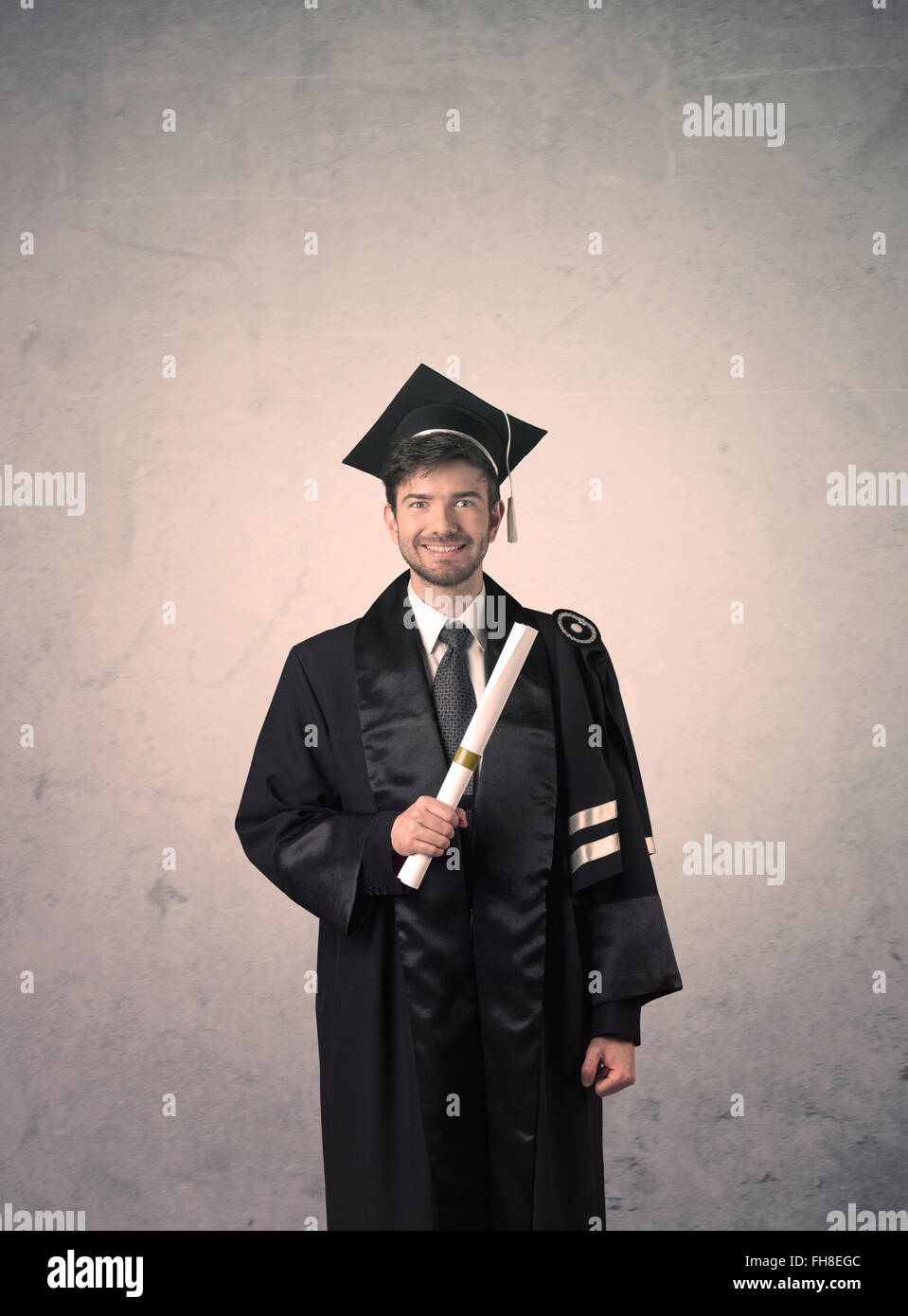 Portrait of a young graduate student on grungy background Stock Photo ...