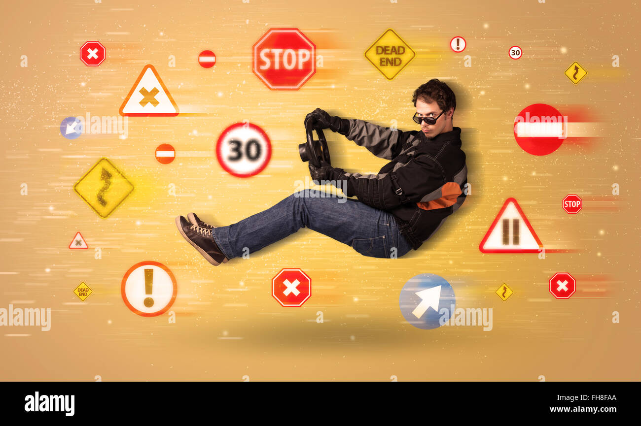 Young driver with road signs around him Stock Photo - Alamy