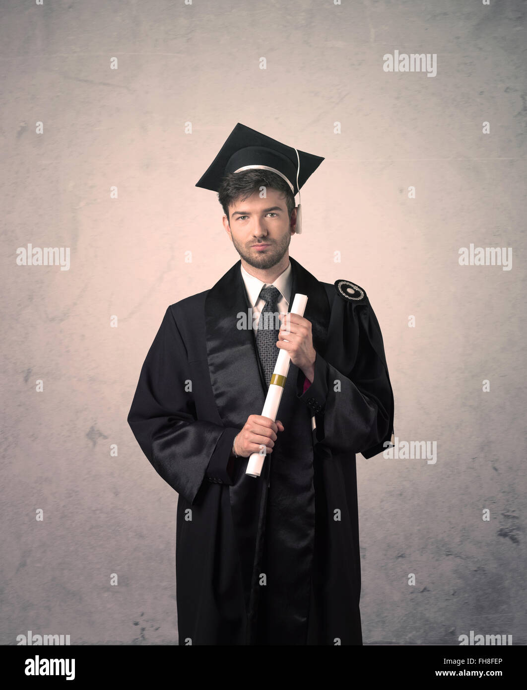 Portrait of a young graduate student on grungy background Stock Photo ...
