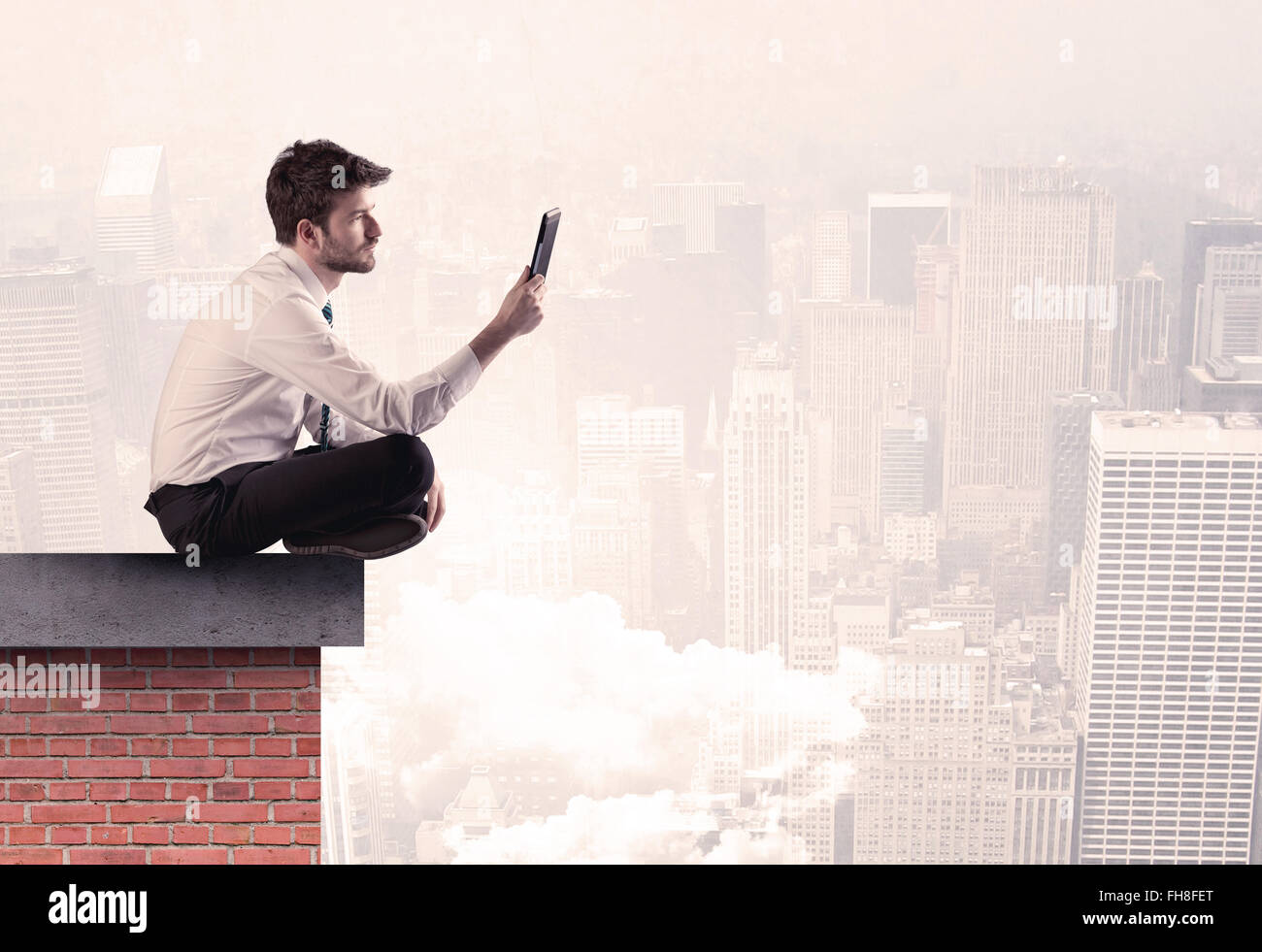 Office worker sitting on rooftop in city Stock Photo - Alamy