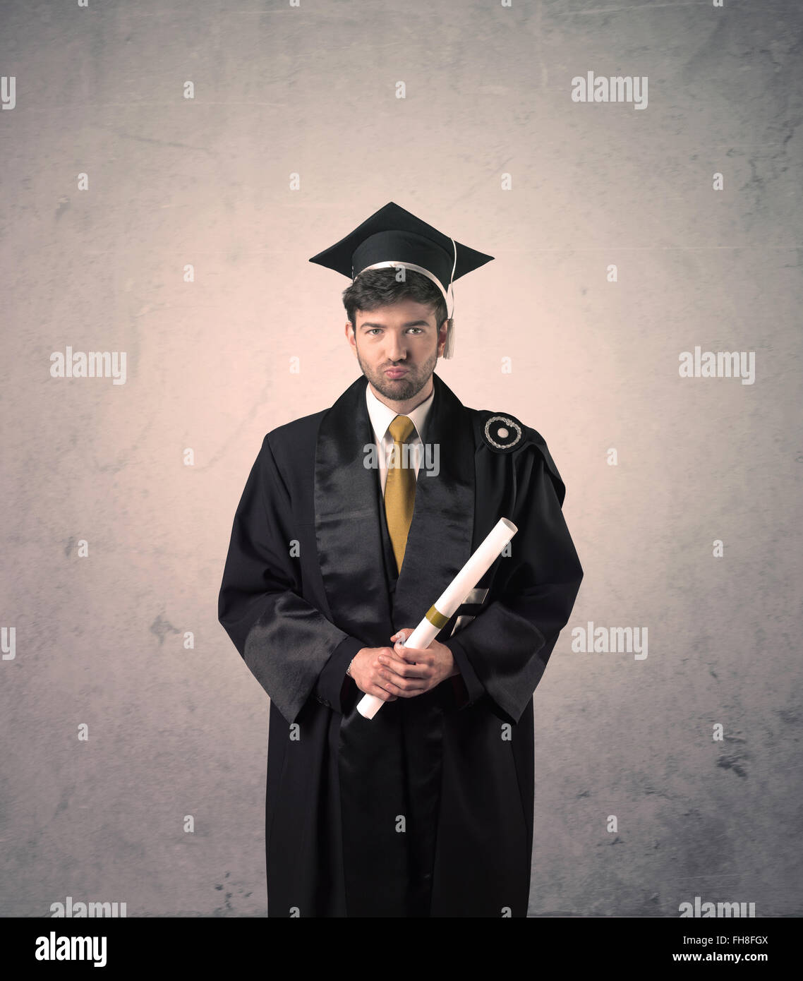 Portrait of a young graduate student on grungy background Stock Photo ...