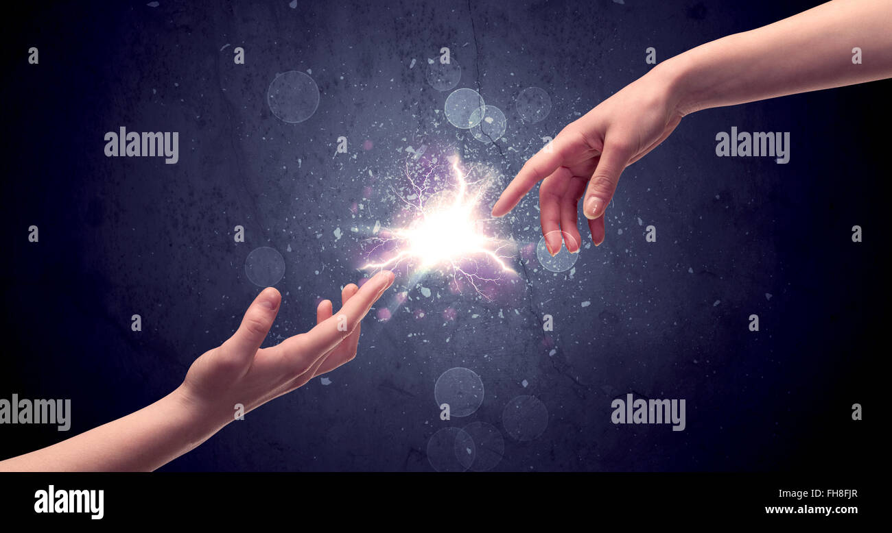 Hands reaching to light a spark Stock Photo - Alamy