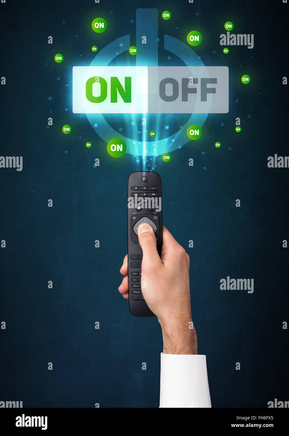 Hand with remote control and on-off signals Stock Photo - Alamy
