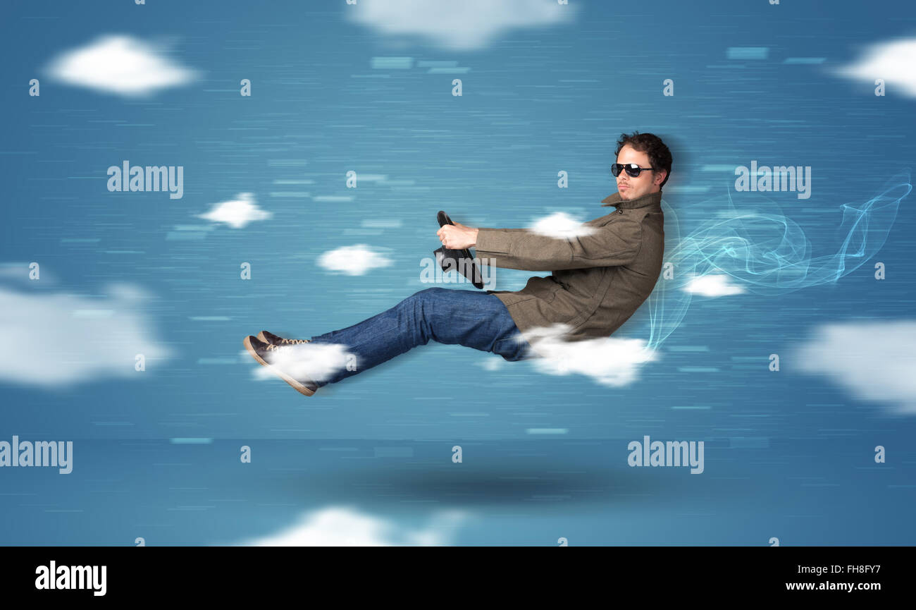 Funny racedriver young man driving between clouds concept Stock Photo ...