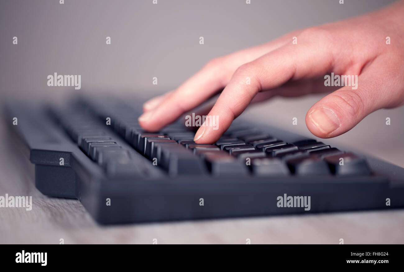 Close up of hand pressing keyboard buttons Stock Photo - Alamy
