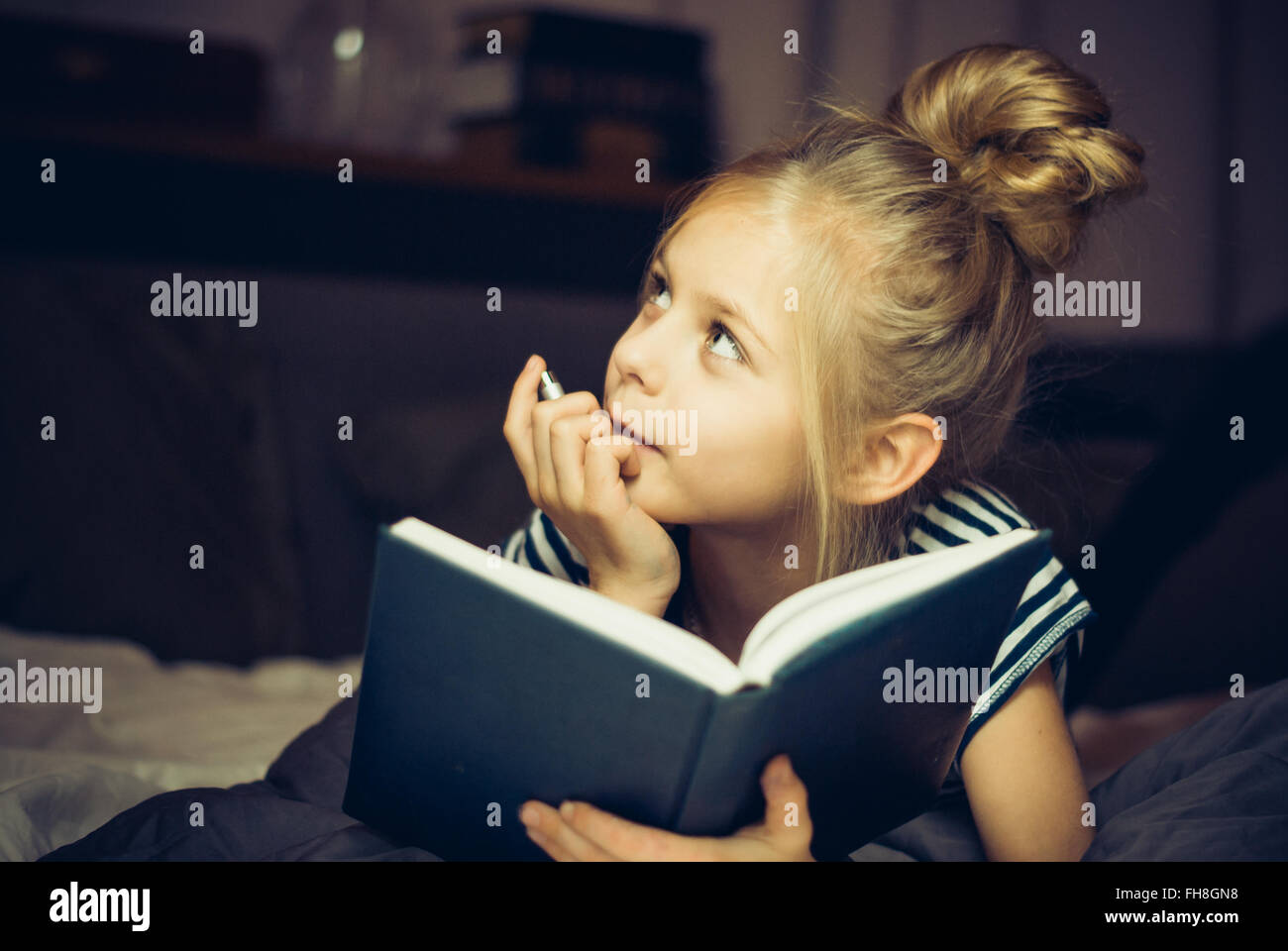 Girl reading a book and dreams Stock Photo - Alamy
