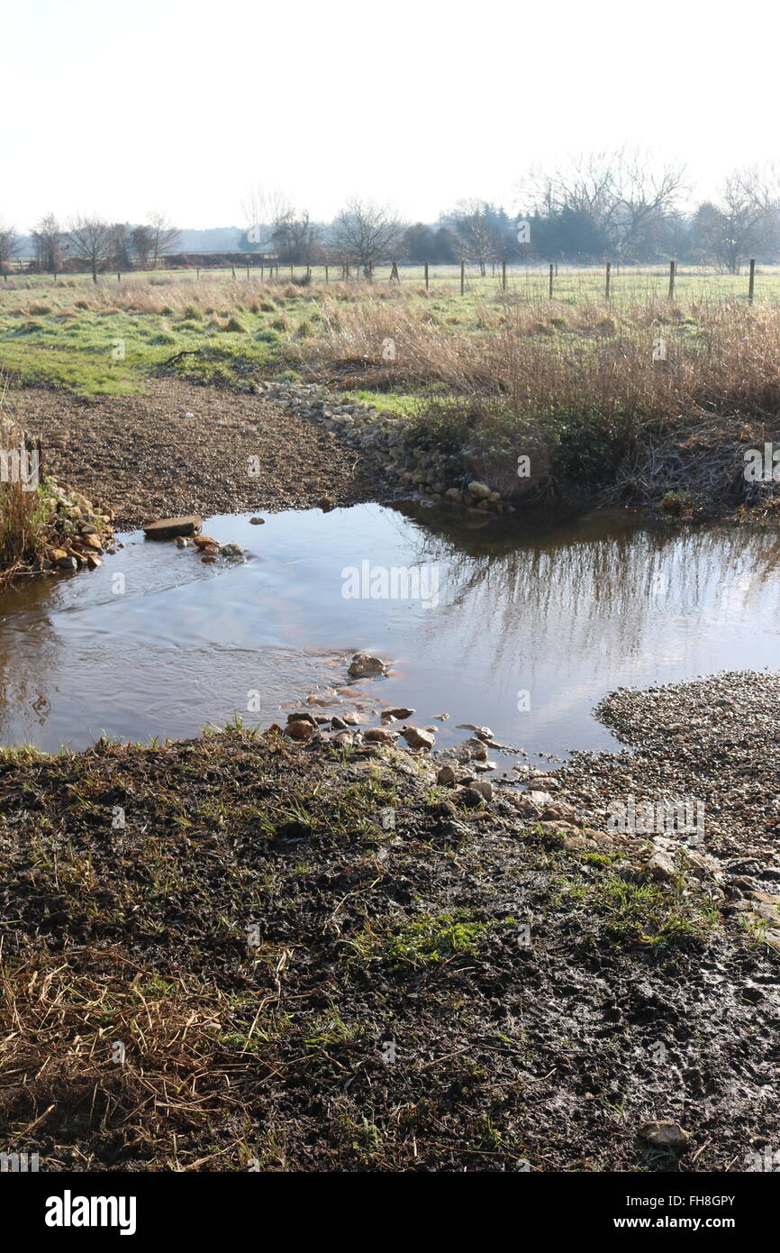 A ford on upper River Bourne near Chobham, Surrey on a bright winter's ...