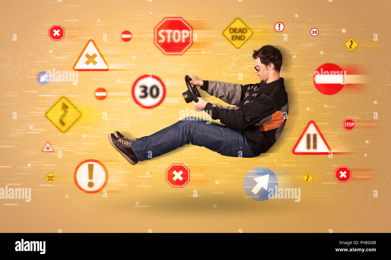 Young driver with road signs around him Stock Photo - Alamy