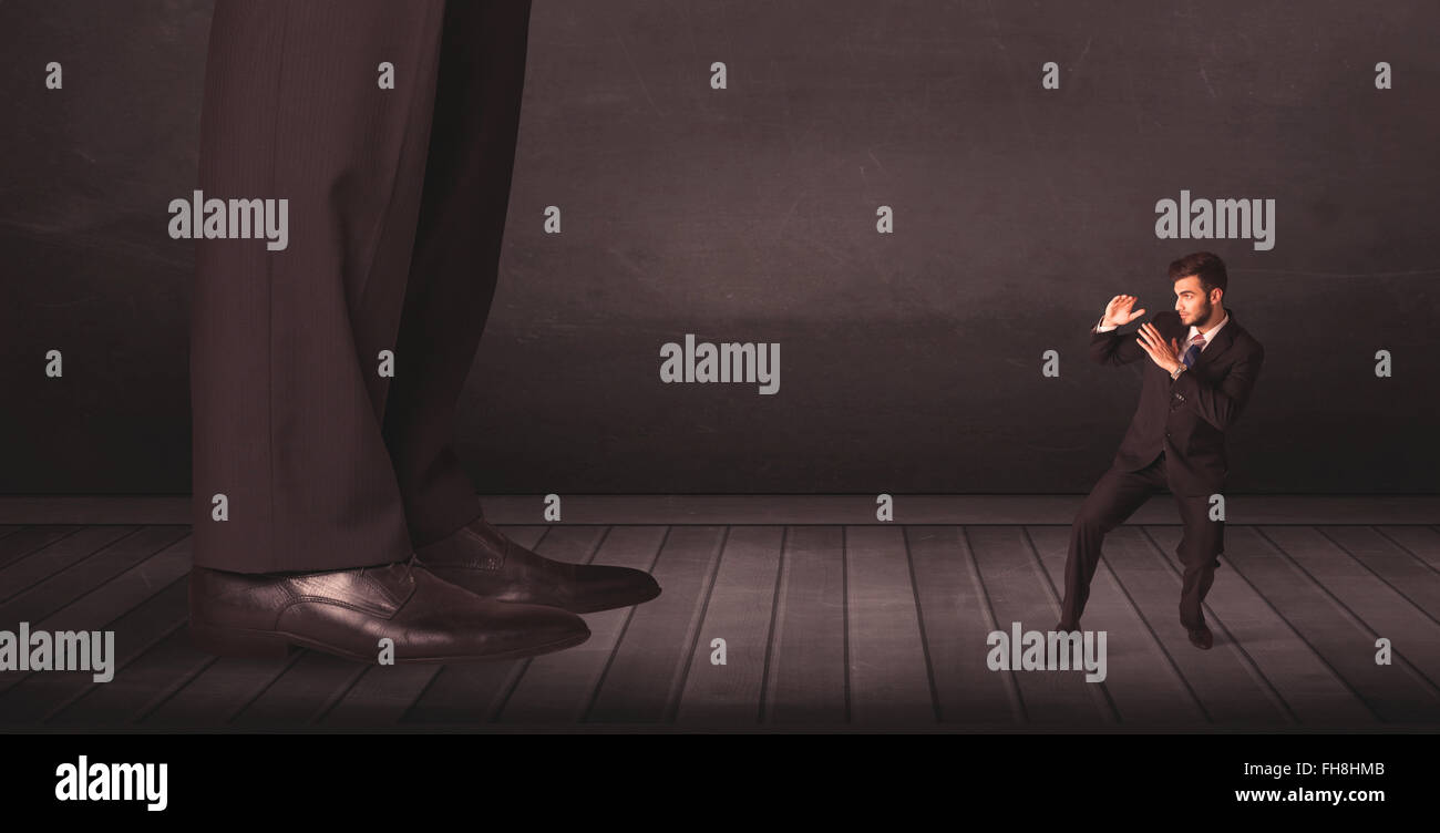 Big person with small businessman concept Stock Photo - Alamy