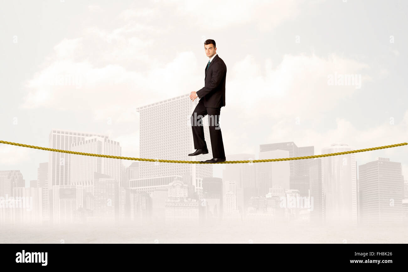 Business person balancing on golden rope Stock Photo - Alamy
