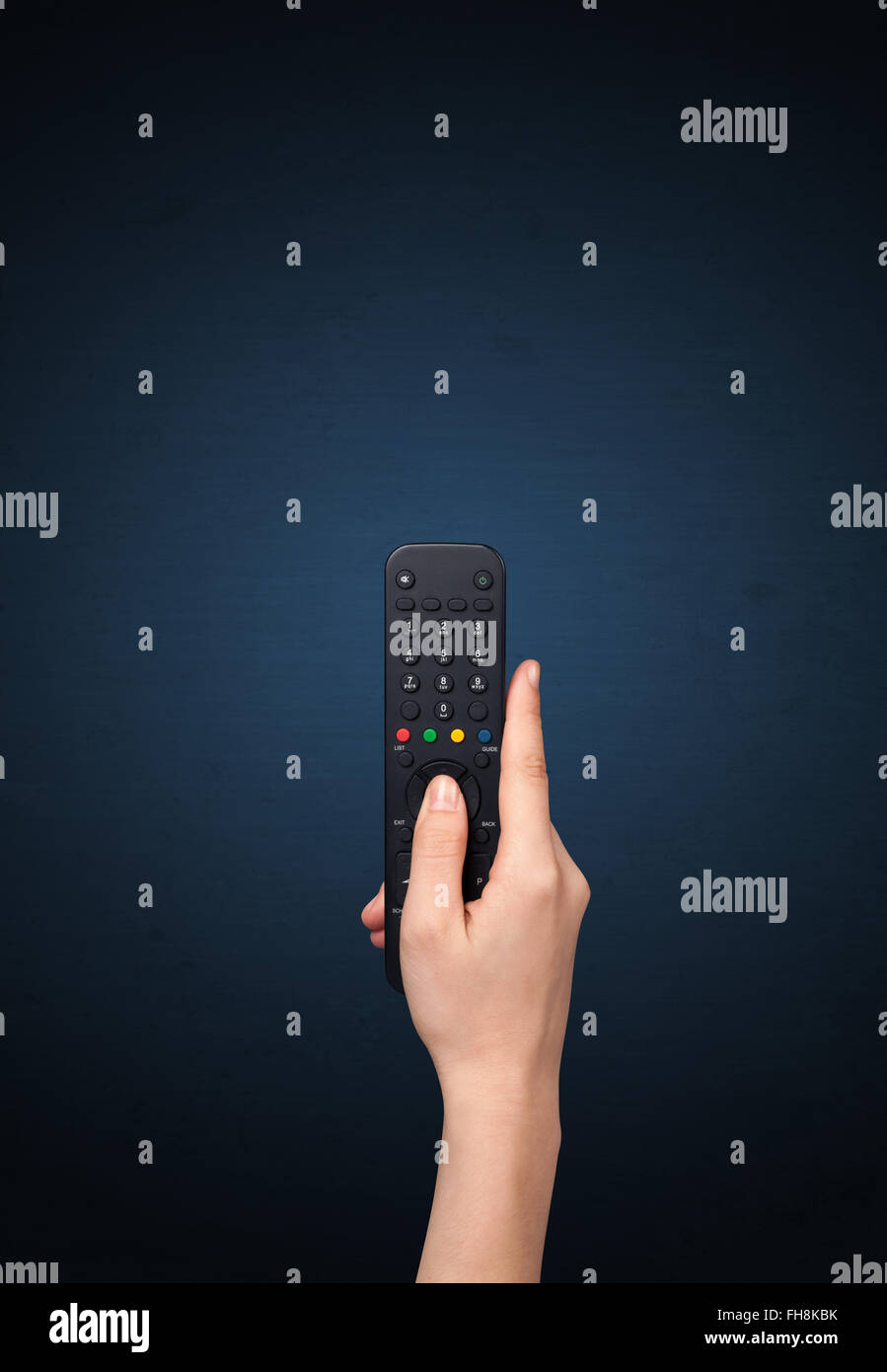 Hand with remote control Stock Photo - Alamy