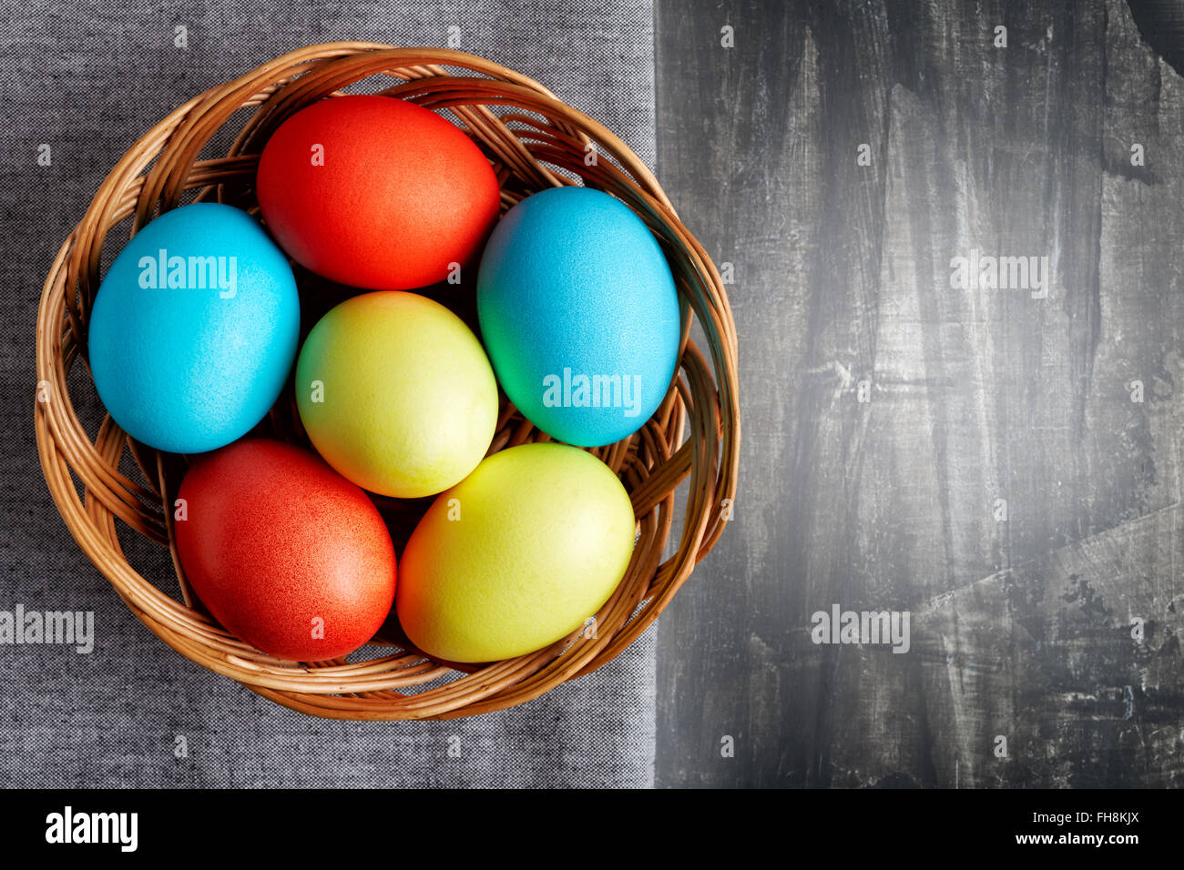 Easter eggs in a wicker basket, top view Stock Photo - Alamy