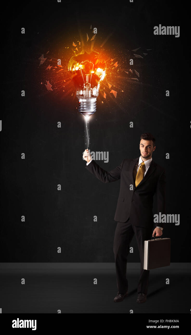 Businessman with an explosion bulb Stock Photo - Alamy