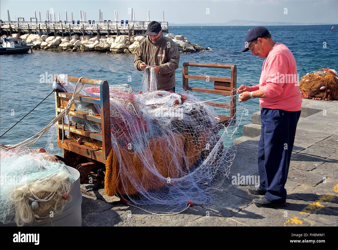 Fishing port men mending nets hi-res stock photography and images - Alamy