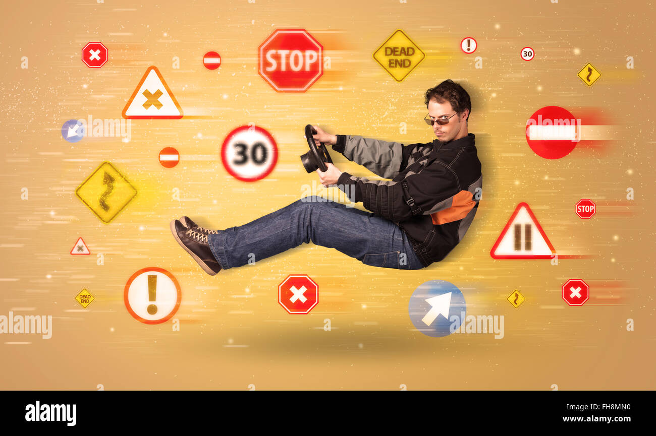 Young driver with road signs around him Stock Photo - Alamy